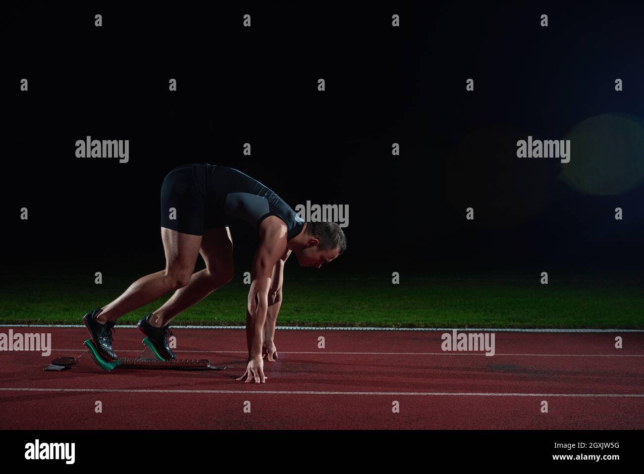 Sprinter leaving starting blocks on the running track. Explosive start ...