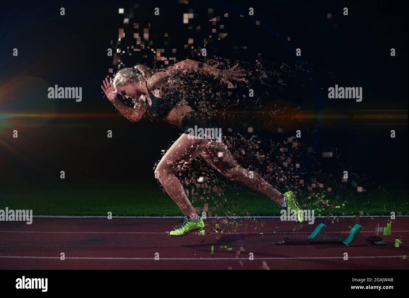 woman sprinter leaving starting blocks on the athletic track. Side view ...