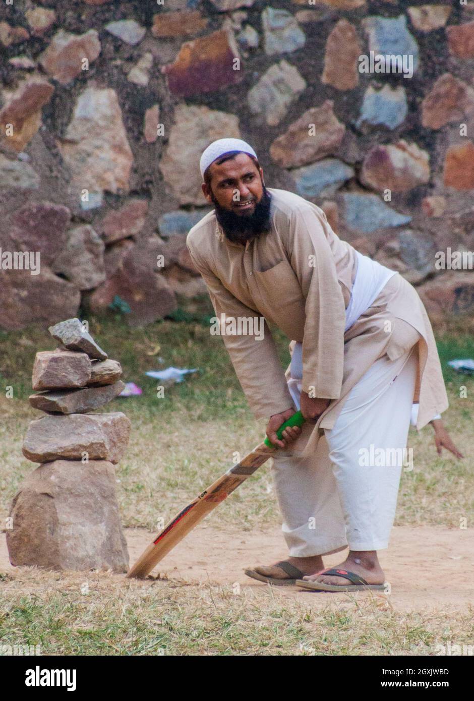 DELHI, INDIA - OCTOBER 23, 2016: Muslim man plays cricket near Jamali ...