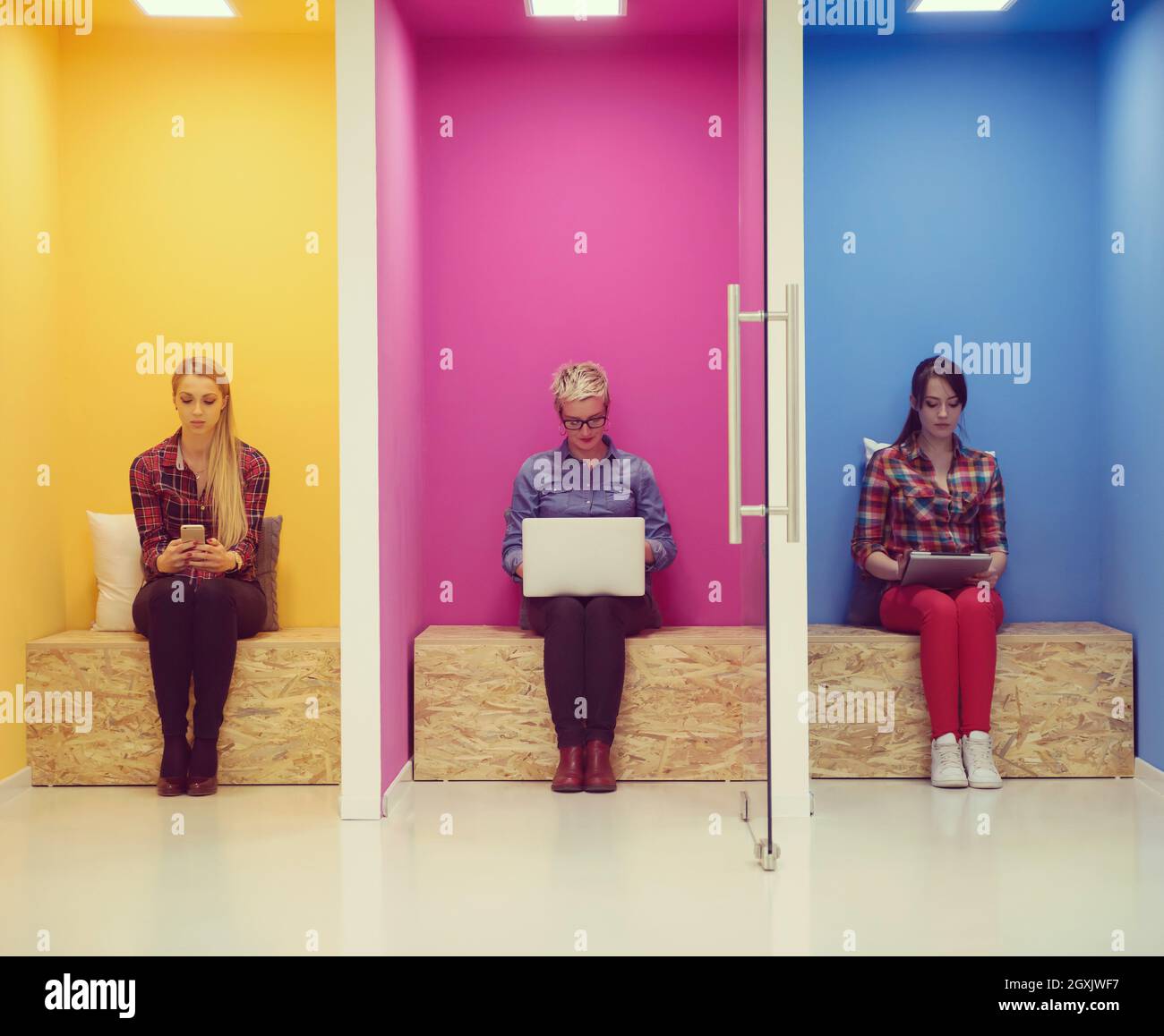 group of young business people having fun, relaxing and working in ...