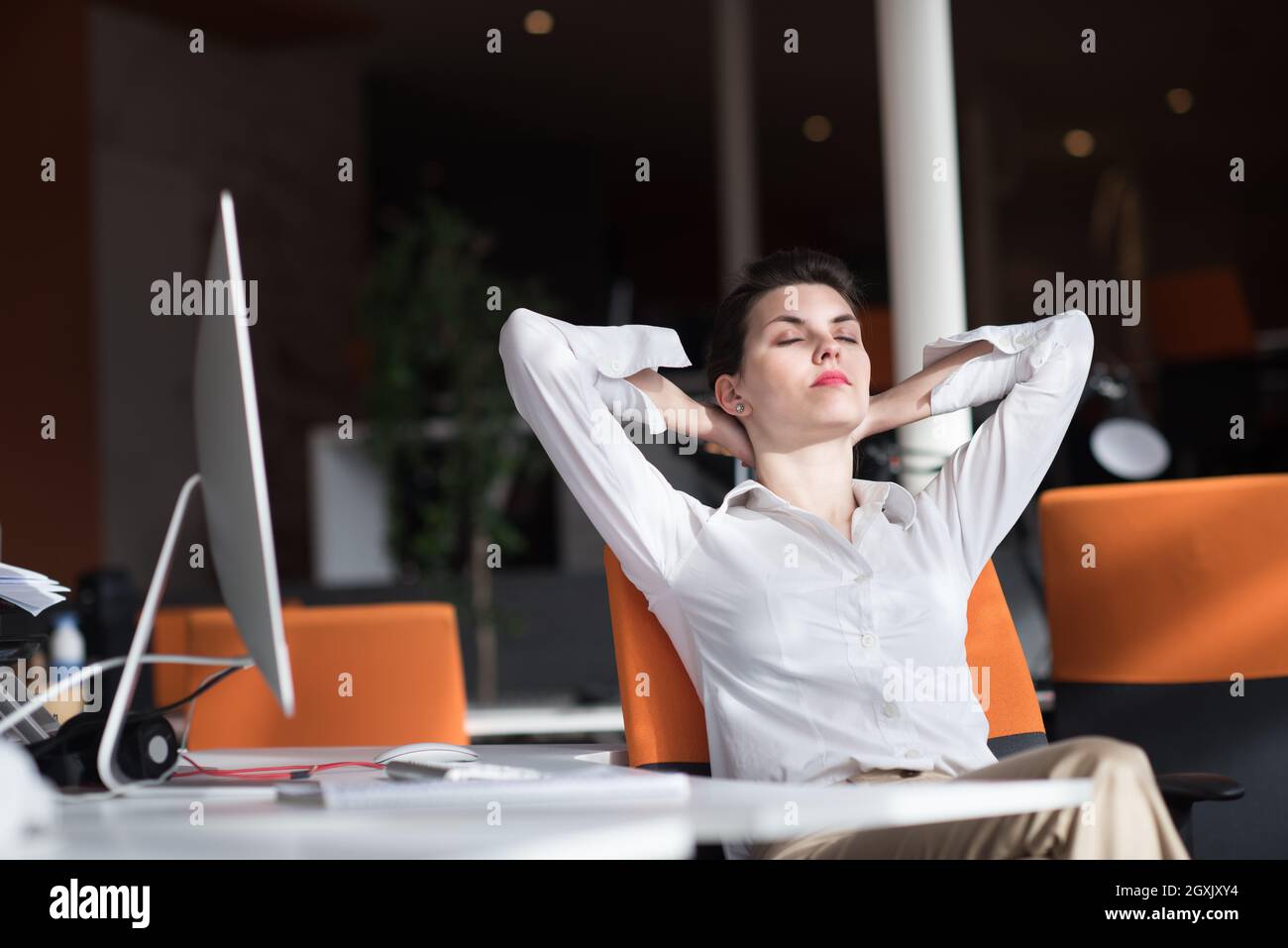 happy young business woman relaxing and geting insiration while working ...