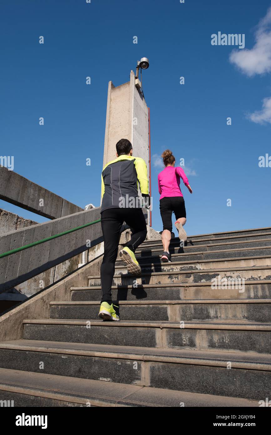 healthy young couple jogging on steps at early morning Stock Photo - Alamy