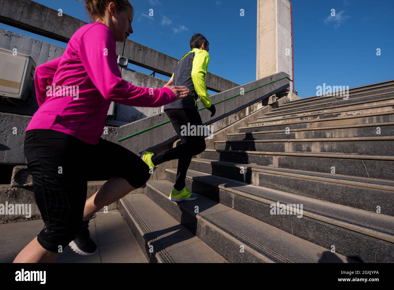 healthy young couple jogging on steps at early morning Stock Photo - Alamy