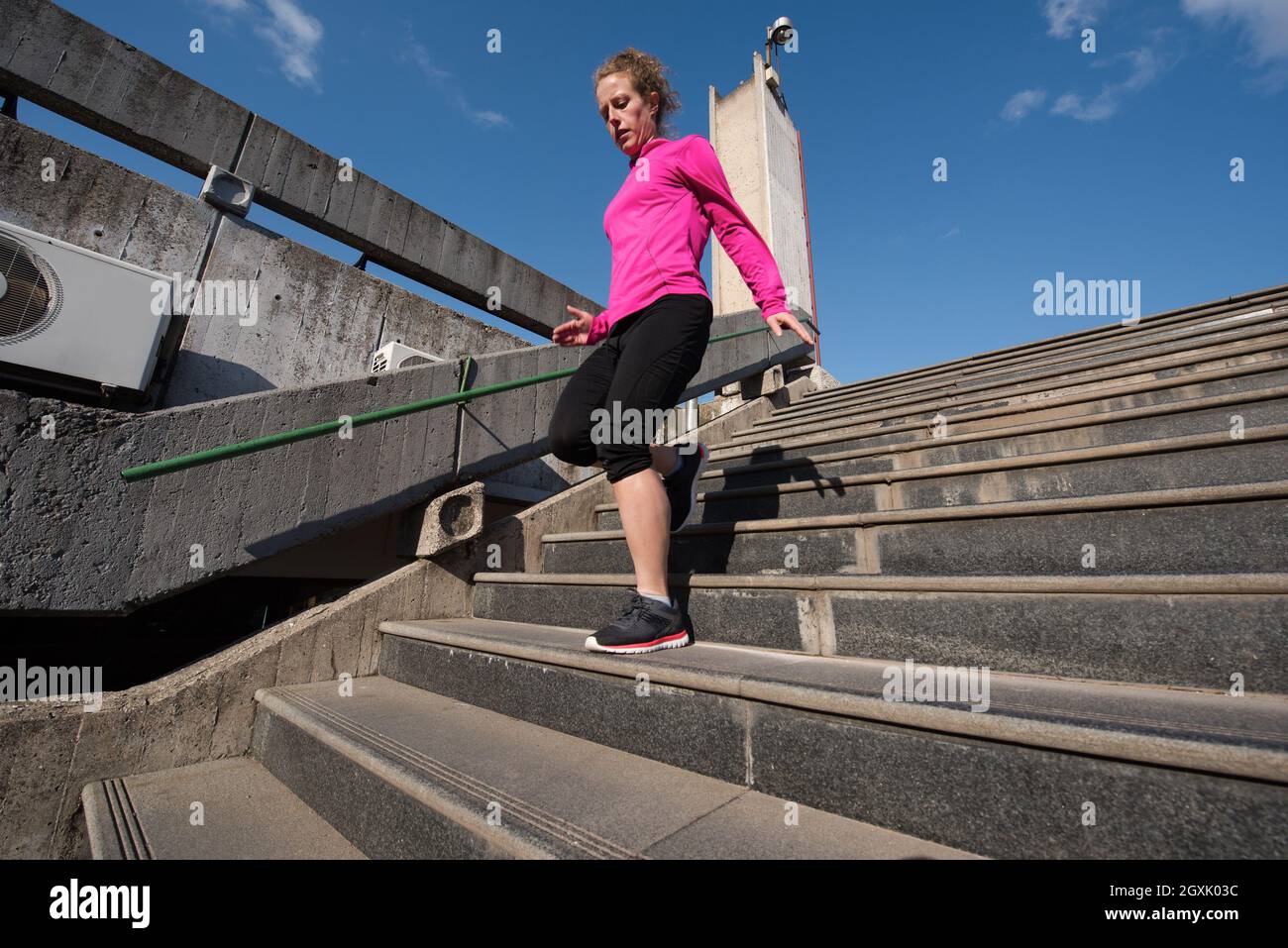 sporty woman running onsteps at early morning jogging Stock Photo - Alamy