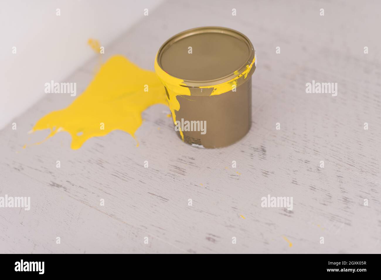 Yellow paint tin can with yellow strokes on the wooden floor Stock ...
