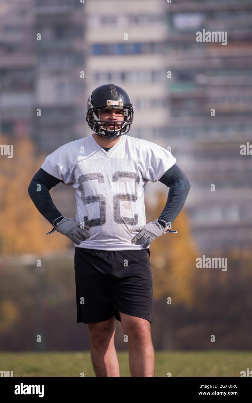 portrait of young confident American football player standing on a ...