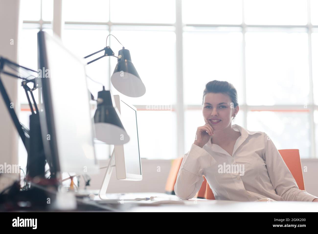 business woman working on desktop computer at modern startup office ...