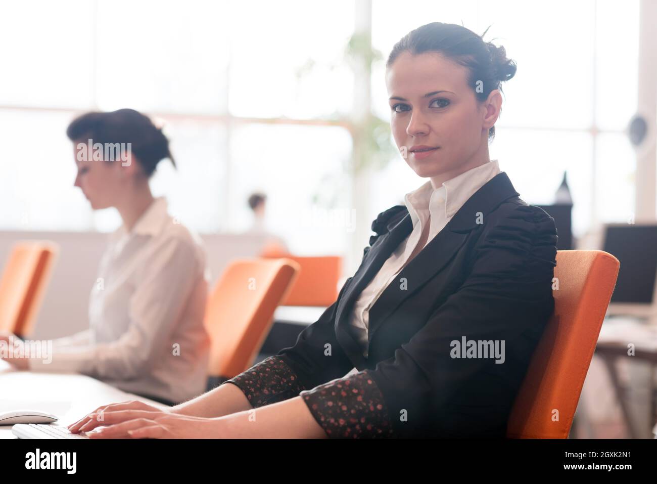 business woman working on desktop computer at modern startup office ...