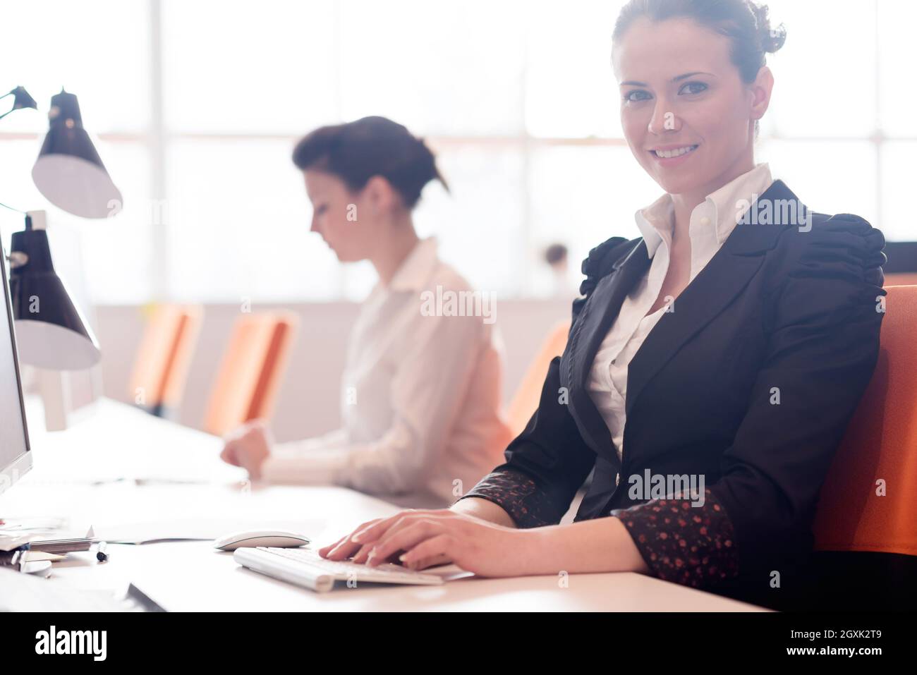 business woman working on desktop computer at modern startup office ...