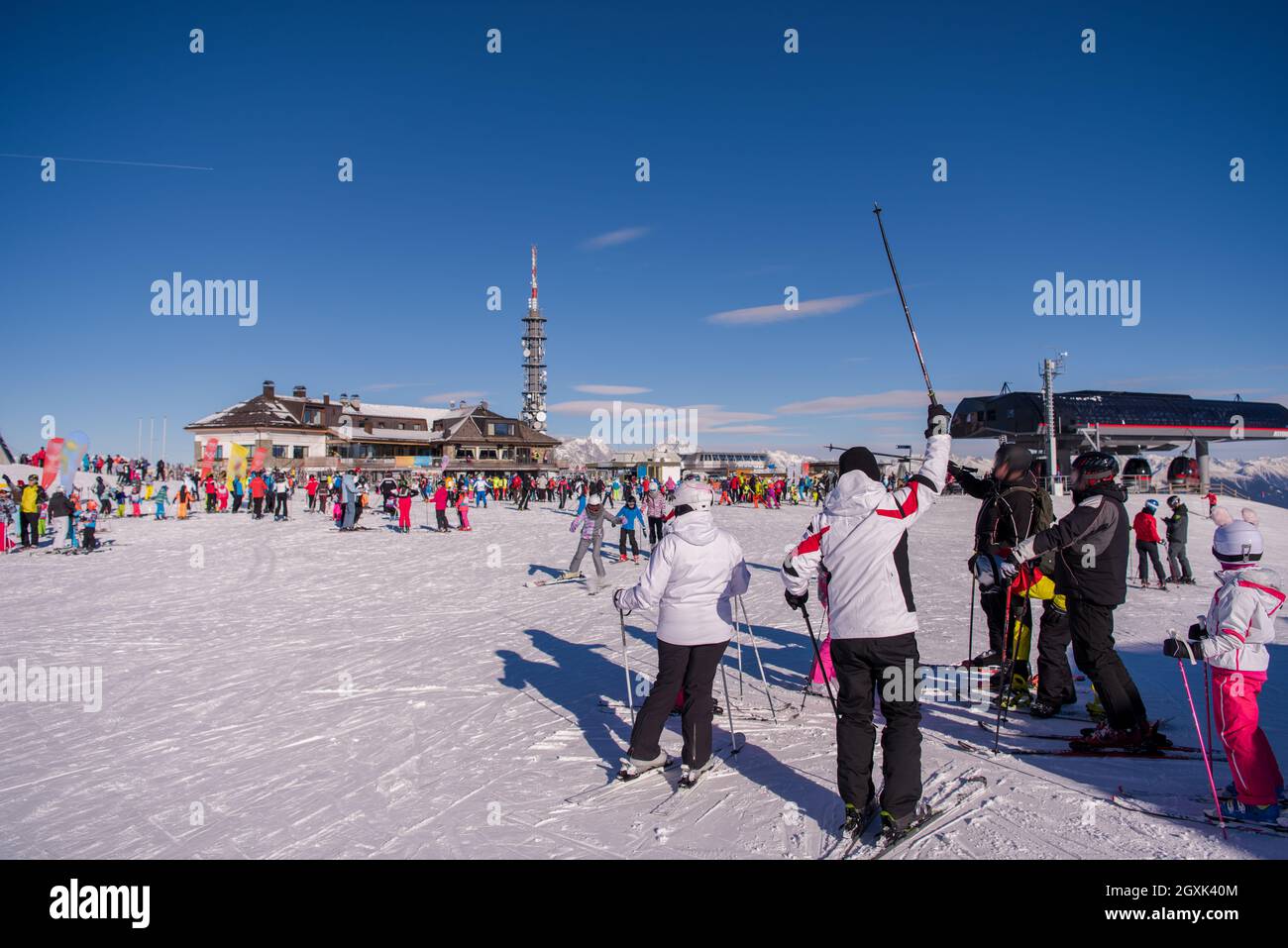 group of happy people having fun on snow during winter season at ...