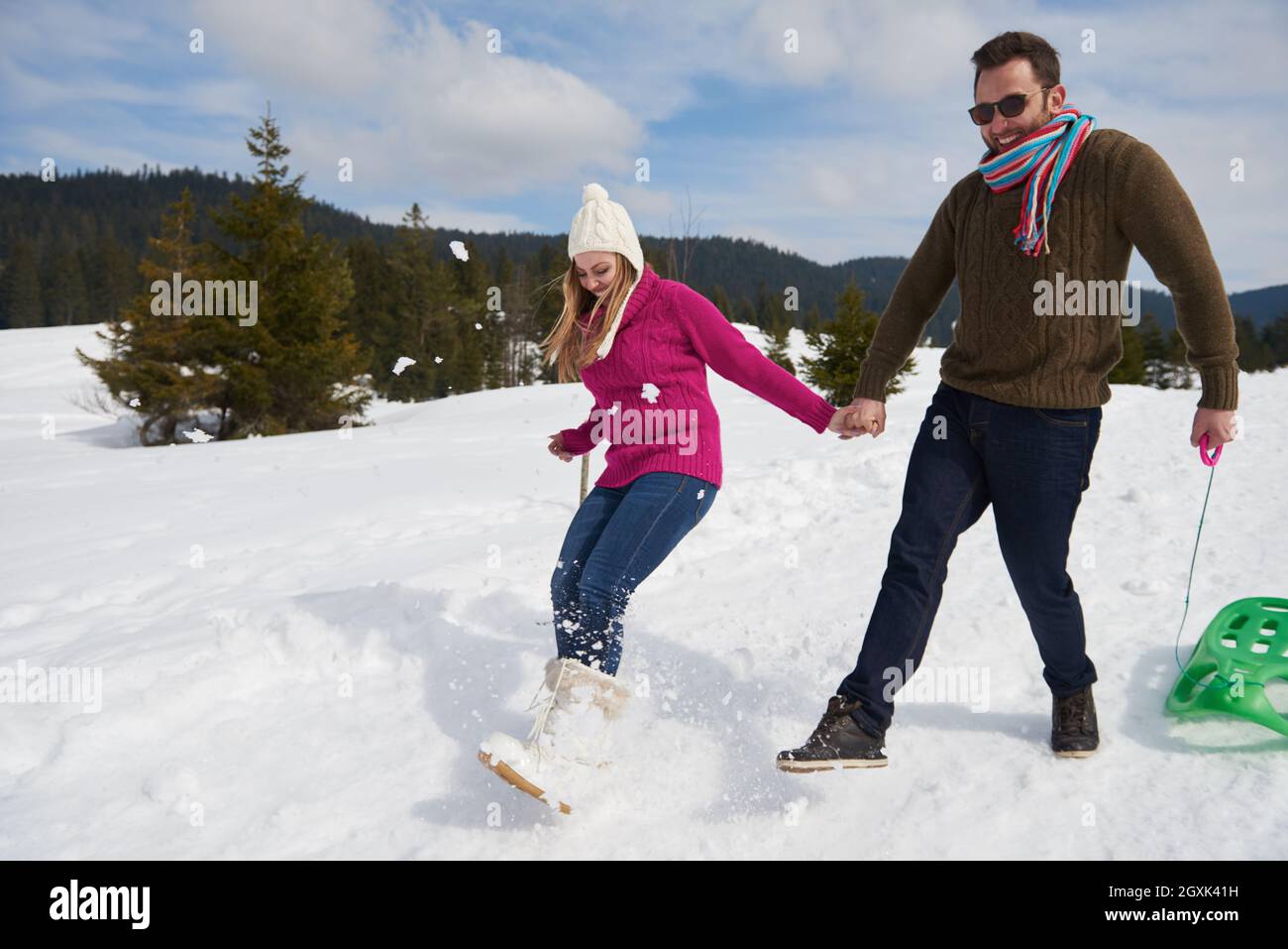 romantic winter scene, happy young couple having fun on fresh show on ...