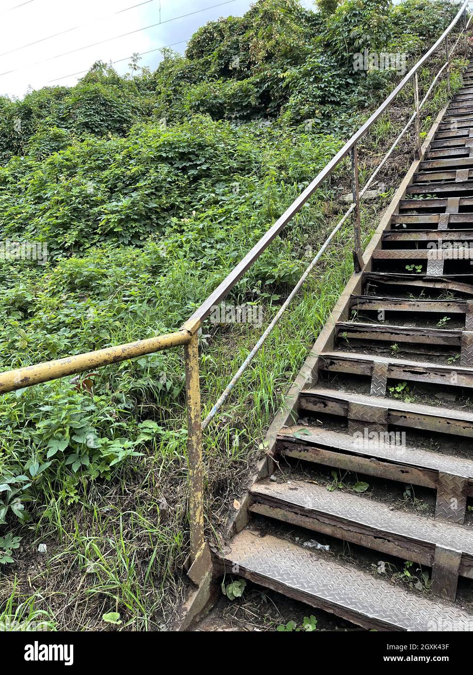 Old metal stairs on green hill outdoors Stock Photo - Alamy