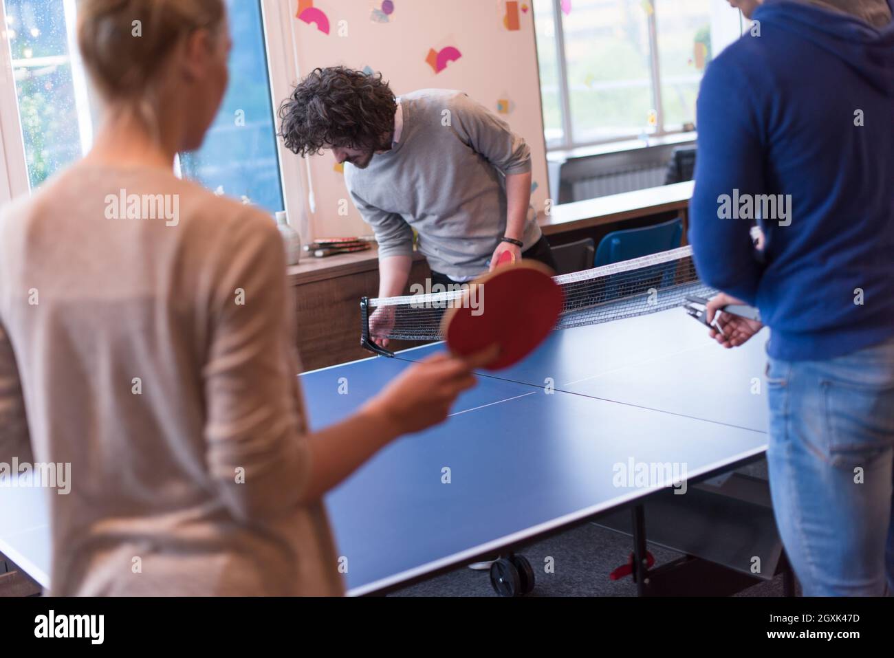 group of young startup business people playing ping pong tennis at ...