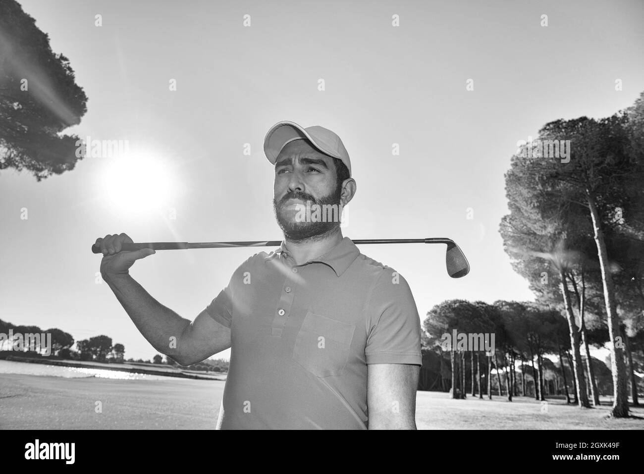 handsome middle eastern golfer portrait at golf course black and white ...