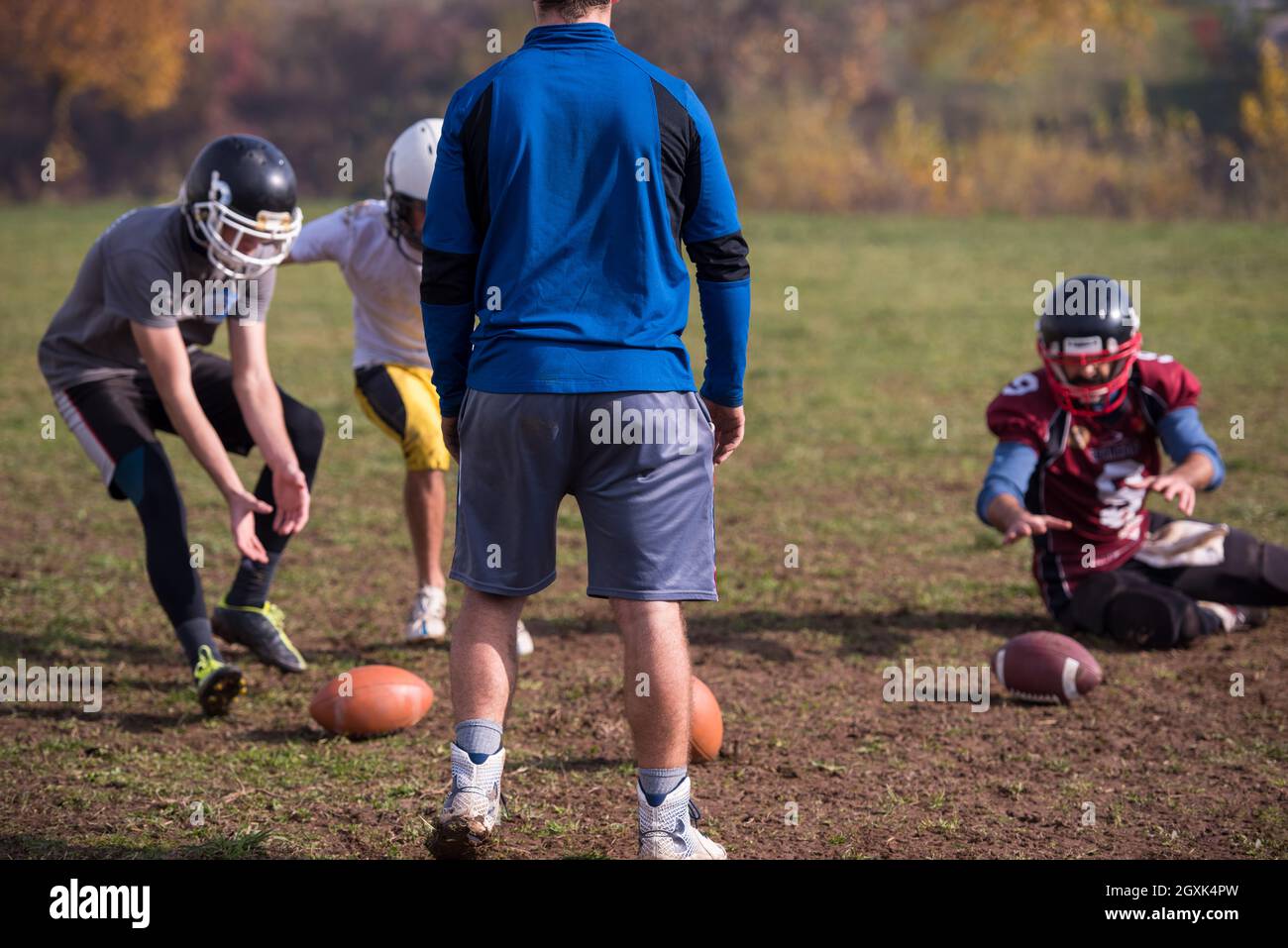 group of young american football players in action during the training ...
