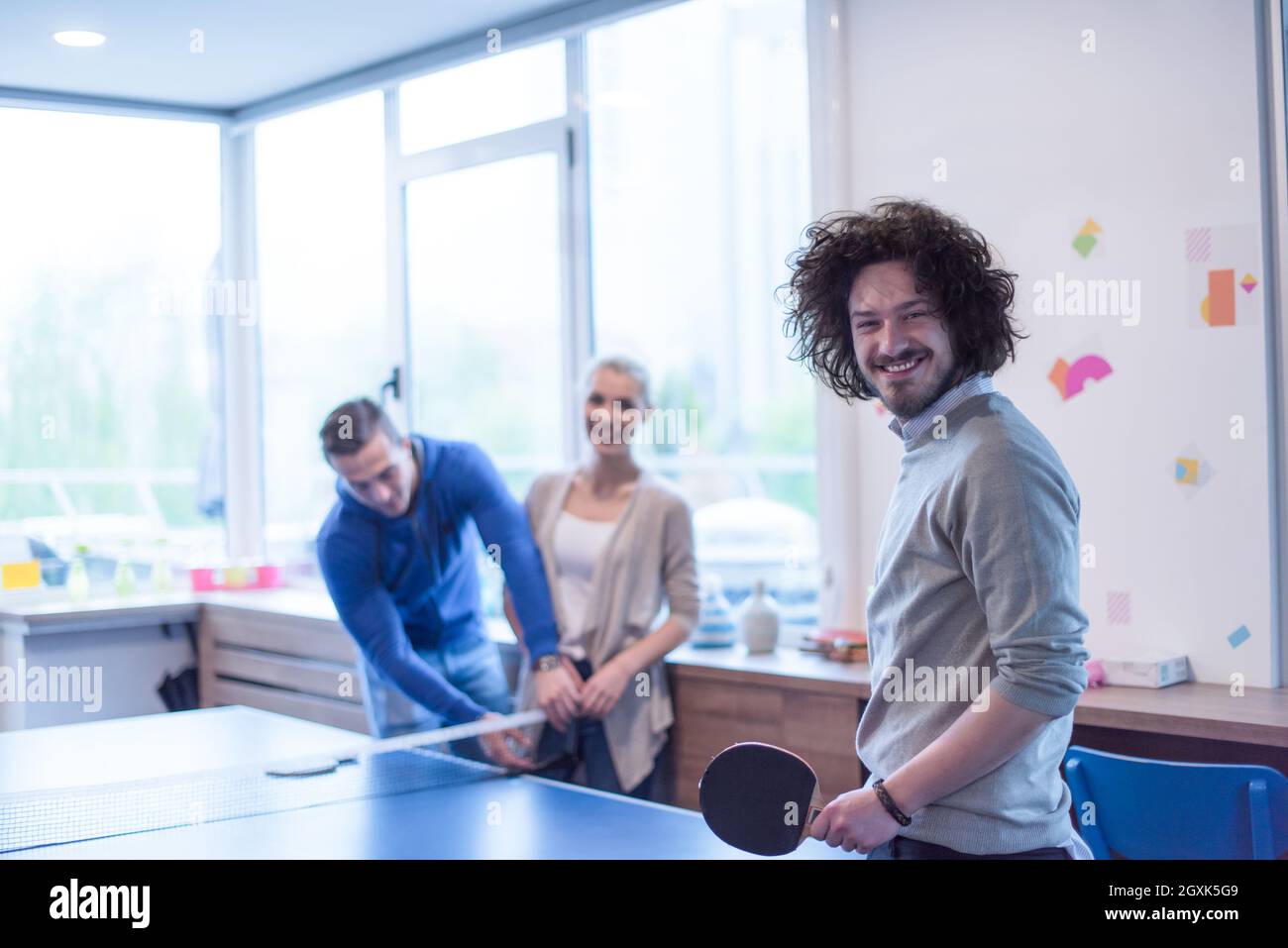 group of young startup business people playing ping pong tennis at ...