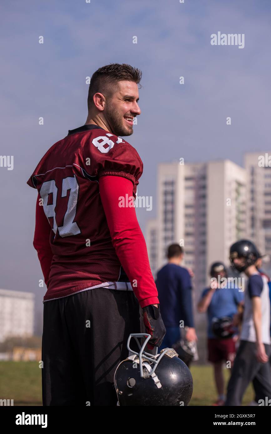 portrait of young confident American football player standing on a ...