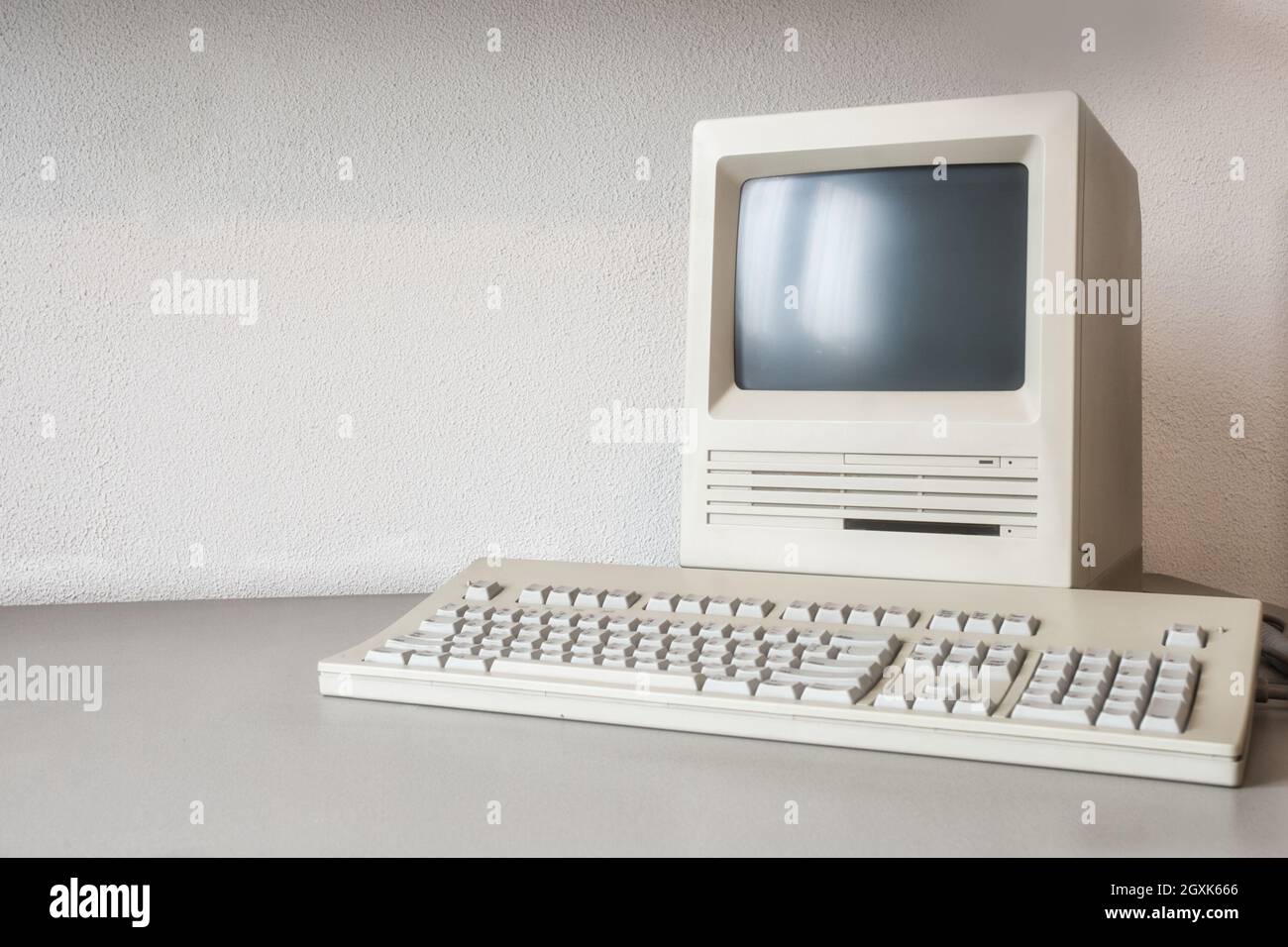 Old vintage monitor and computer on desk, retro workplace with copy ...