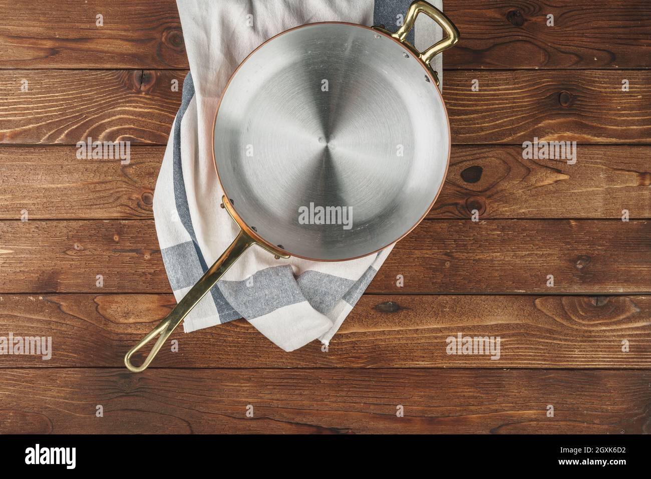 Clean shiny copper kitchenware on wooden board Stock Photo - Alamy