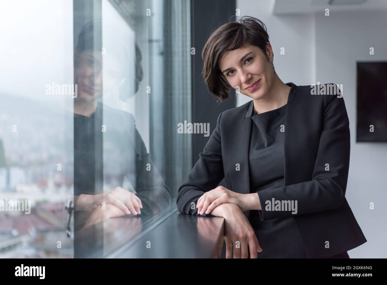 Portrait Of Successful Businesswoman by the window Entrepreneur At Busy ...
