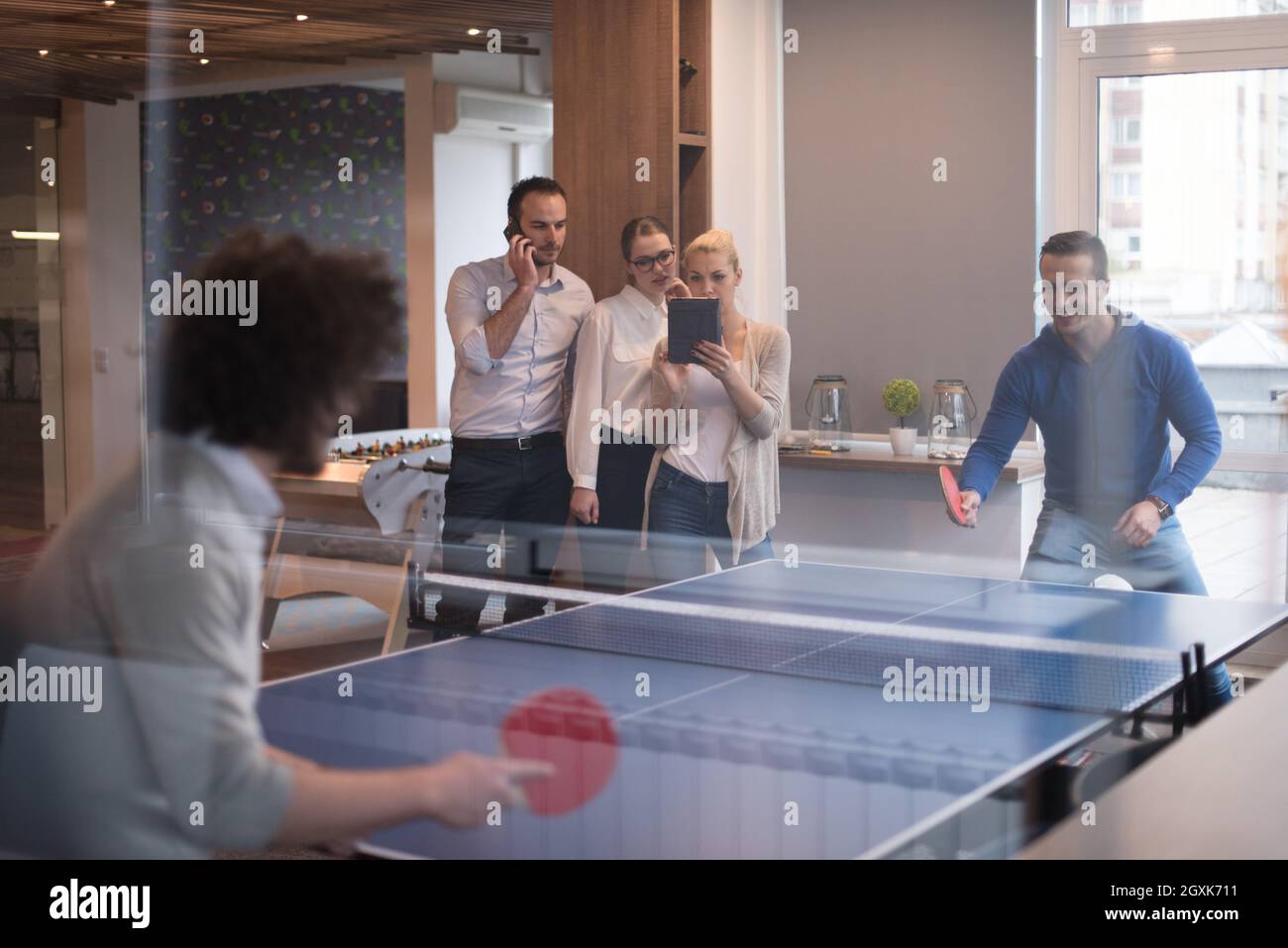 group of young startup business people playing ping pong tennis at ...