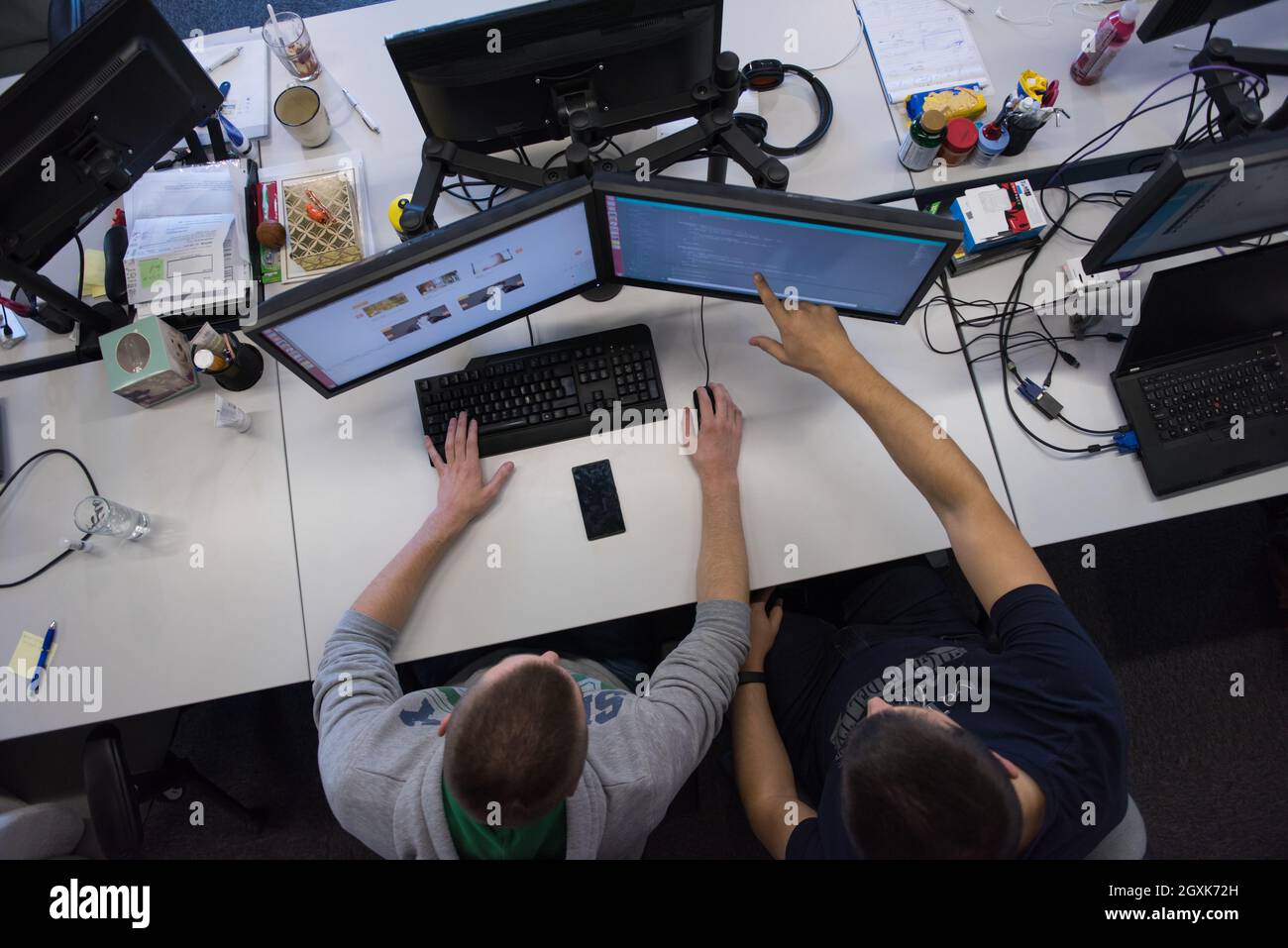 top view of software developers writing programming code on computer ...