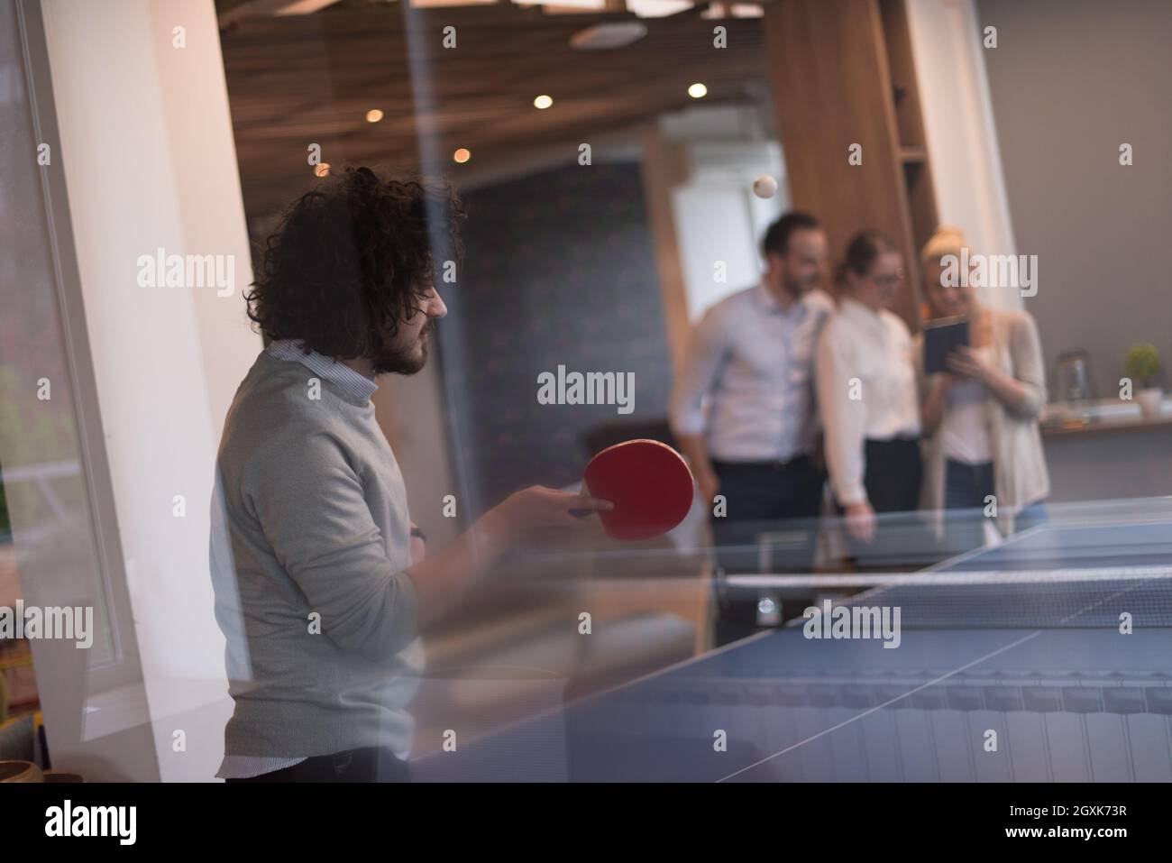 group of young startup business people playing ping pong tennis at ...