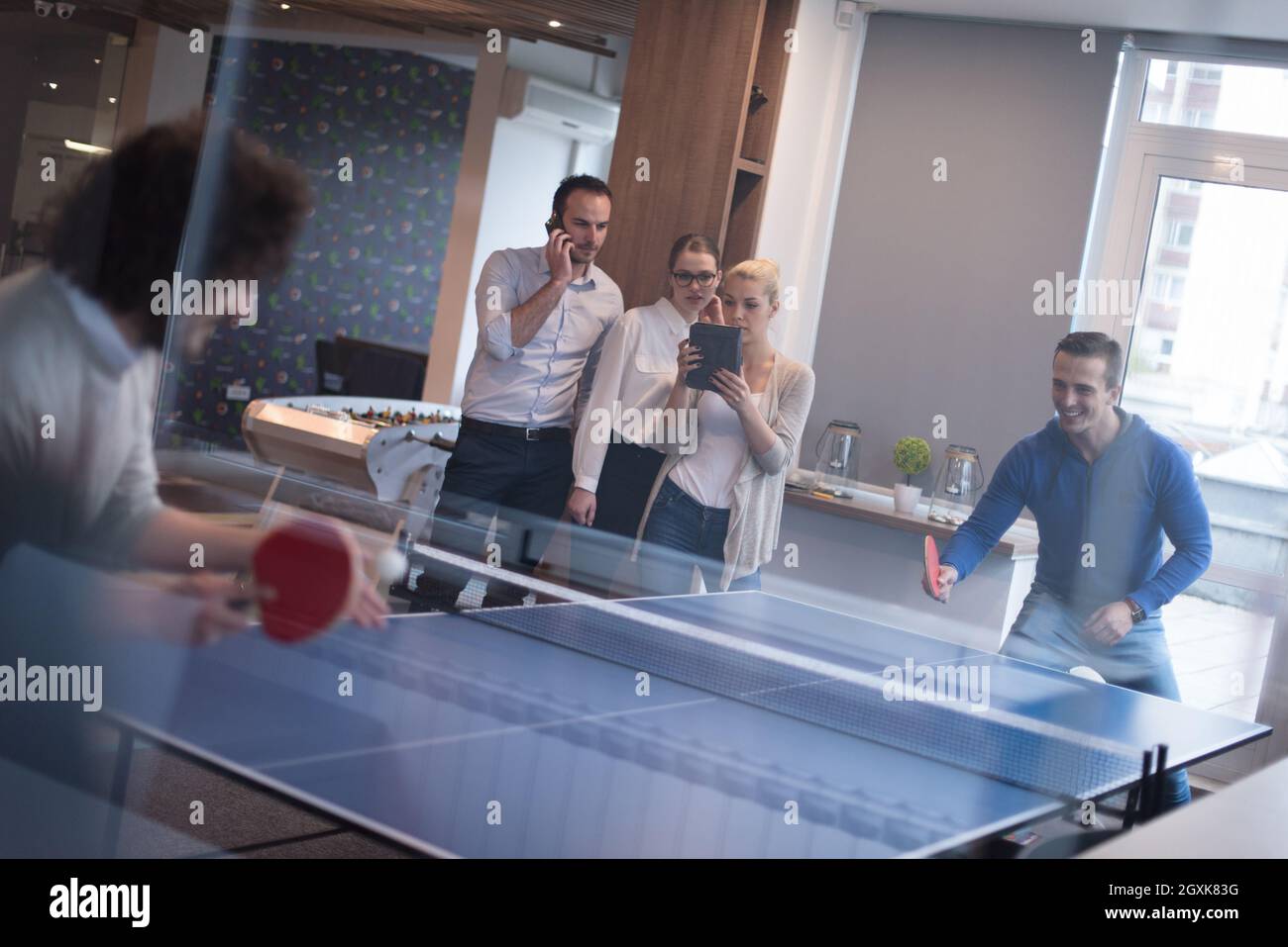 group of young startup business people playing ping pong tennis at ...