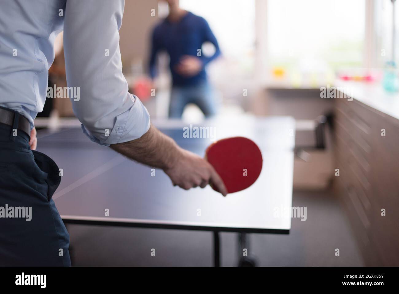 group of young startup business people playing ping pong tennis at ...