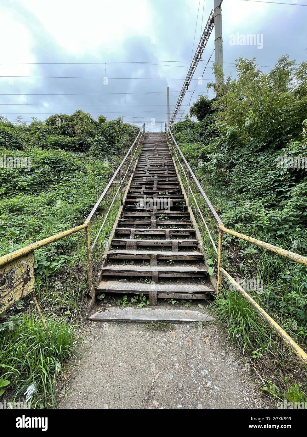 Old metal stairs outdoors under gloomy grey sky Stock Photo - Alamy