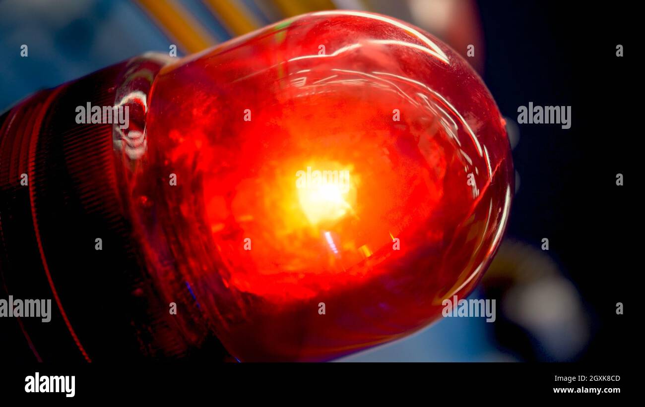 Closeup image of glowing red fire alarm light installed in modern ...