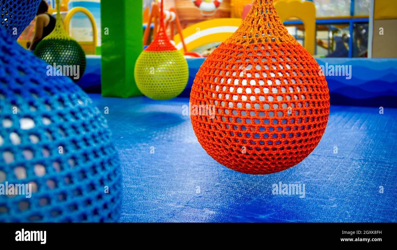 Colorful inflatable balls in nets hanging at gym Stock Photo - Alamy