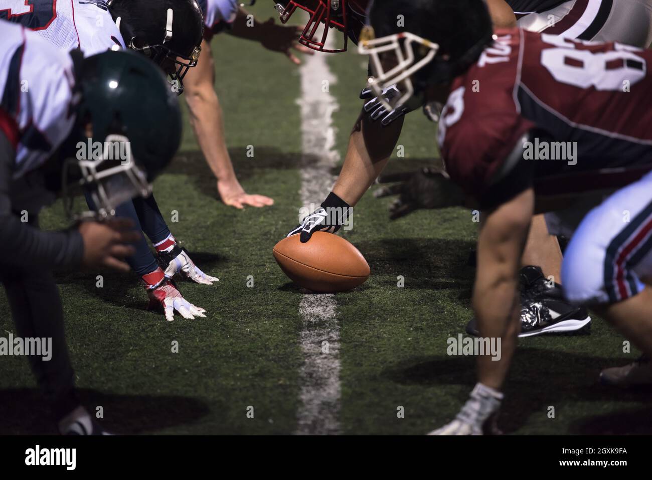 american football players are ready to start on field at night Stock ...
