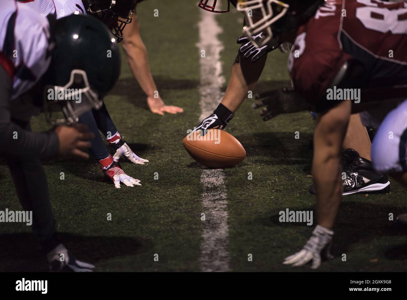 american football players are ready to start on field at night Stock ...
