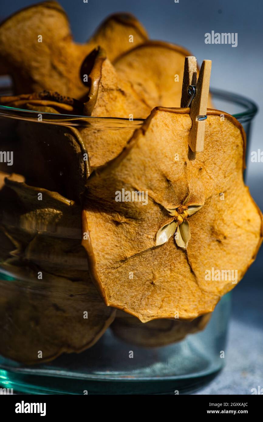 Sliced, dried and dehydrated apple in a glass on a table Stock Photo ...