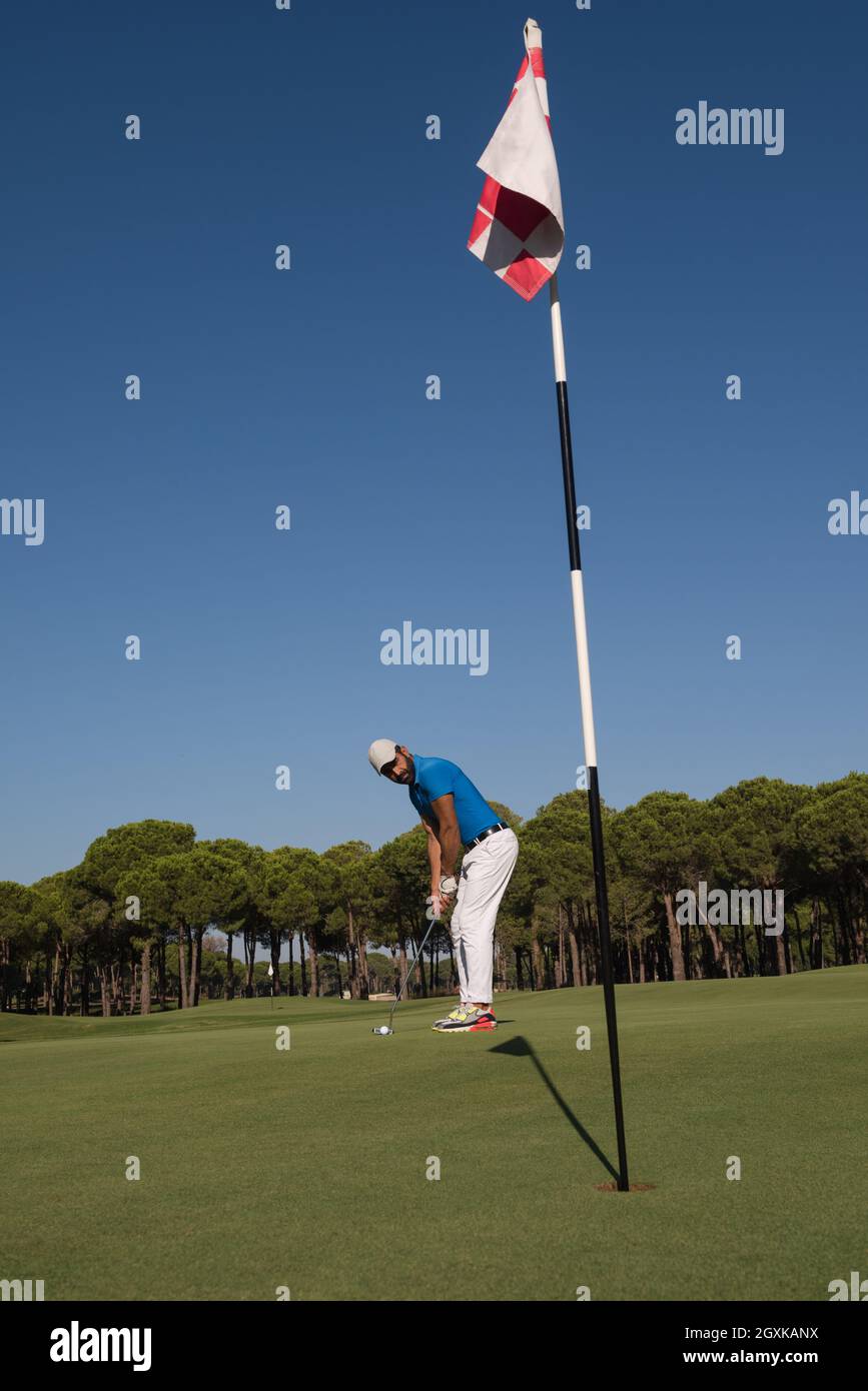 golf player hitting shot with driver on course at beautiful sunny day ...