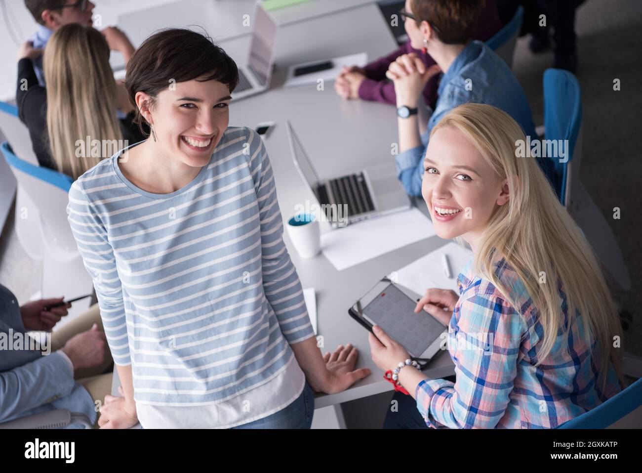 Business Women Using Digital Tablet in Busy Office Stock Photo - Alamy