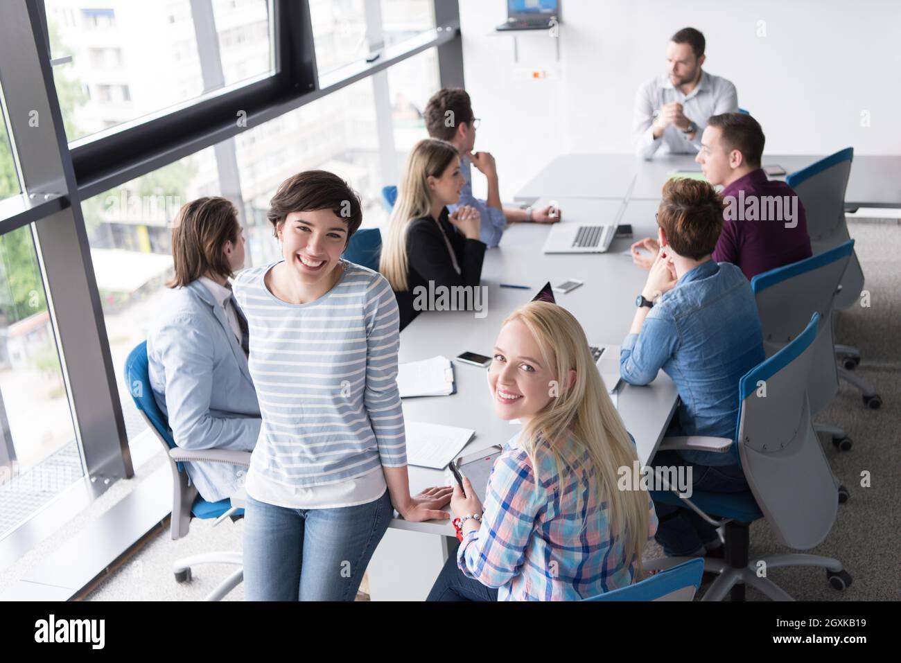 Business Women Using Digital Tablet in Busy Office Stock Photo - Alamy