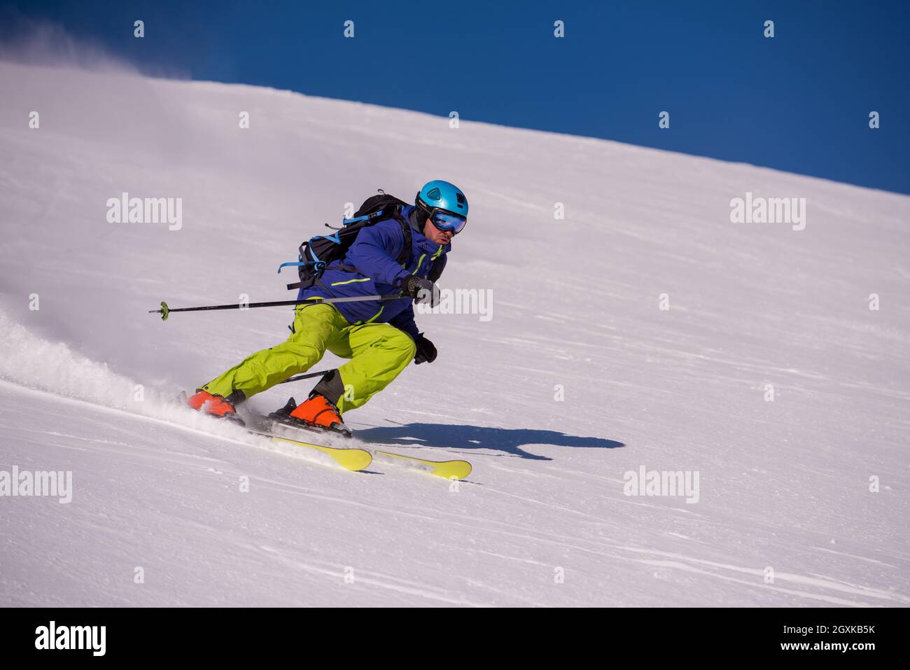 young athlete freestyle Skier having fun while running downhill in ...