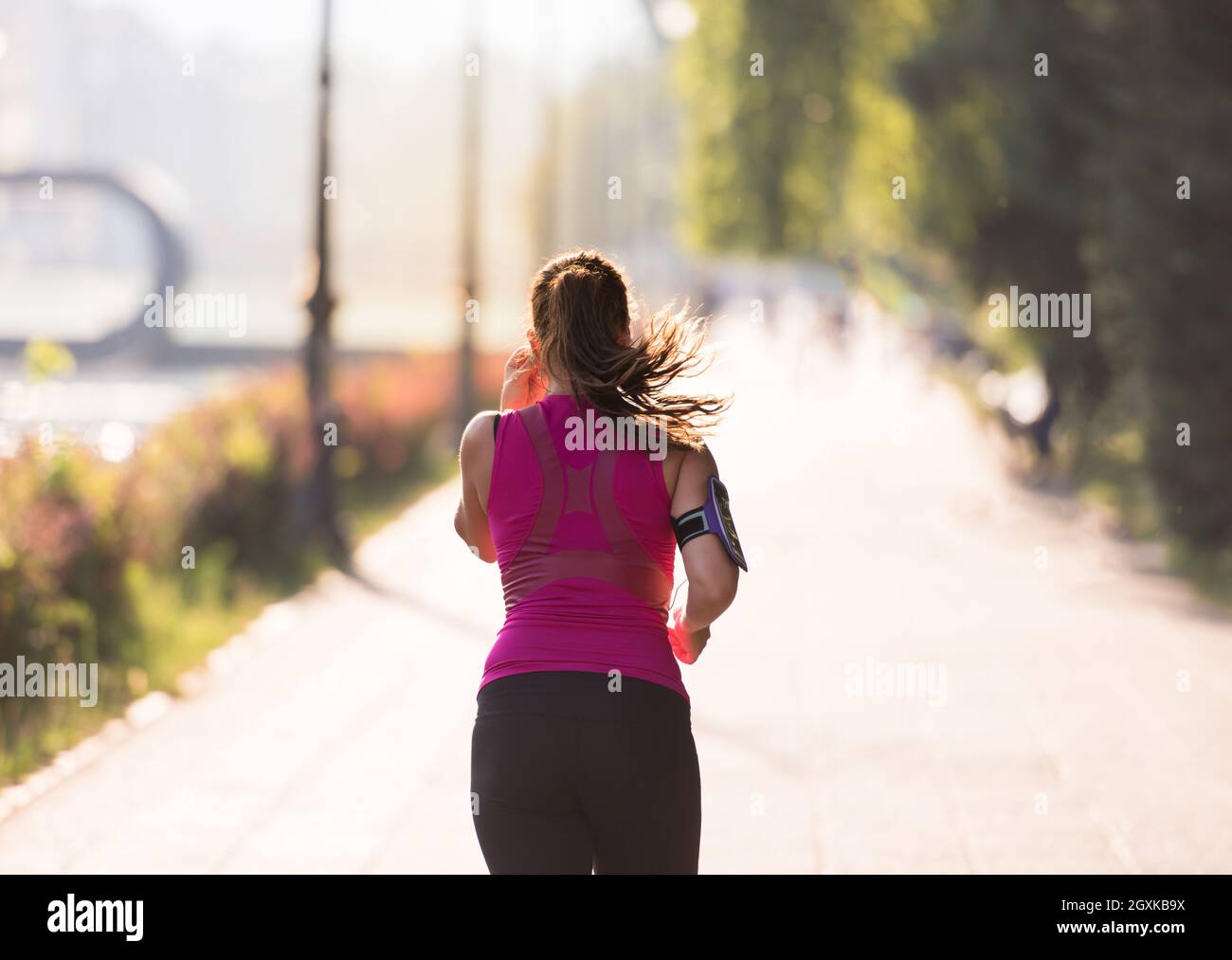 young sporty woman jogging at sunny morning in the city Stock Photo - Alamy