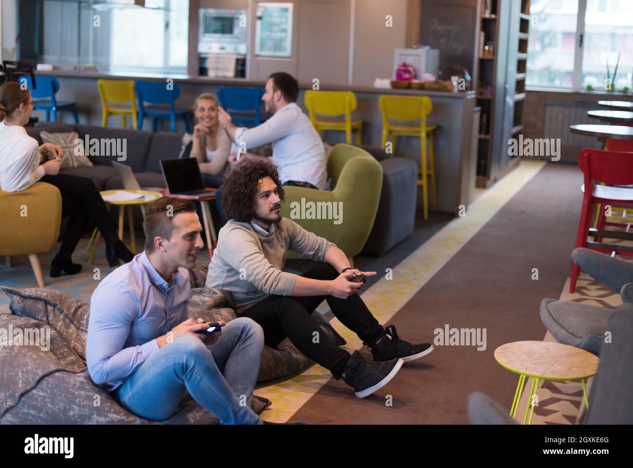 Work hard play hard. Workers Playing computer games in creative startup ...