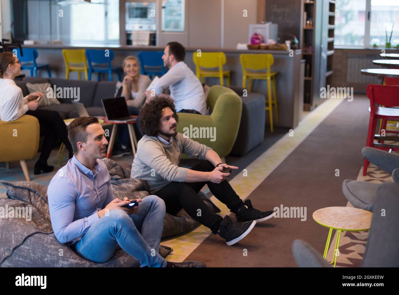 Work hard play hard. Workers Playing computer games in creative startup ...