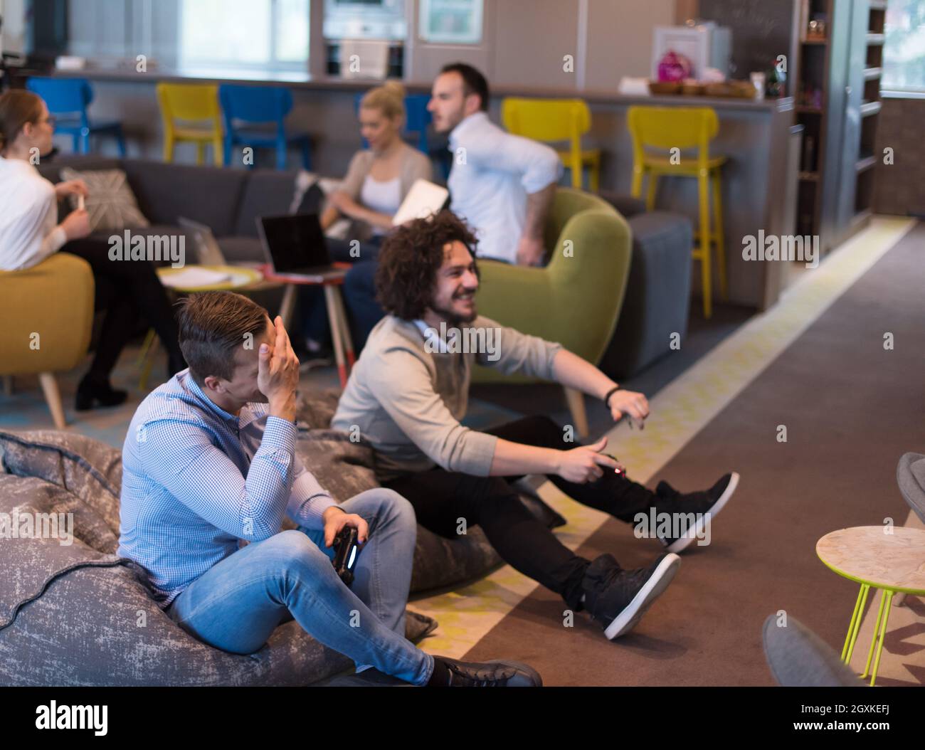 Work hard play hard. Workers Playing computer games in creative startup ...