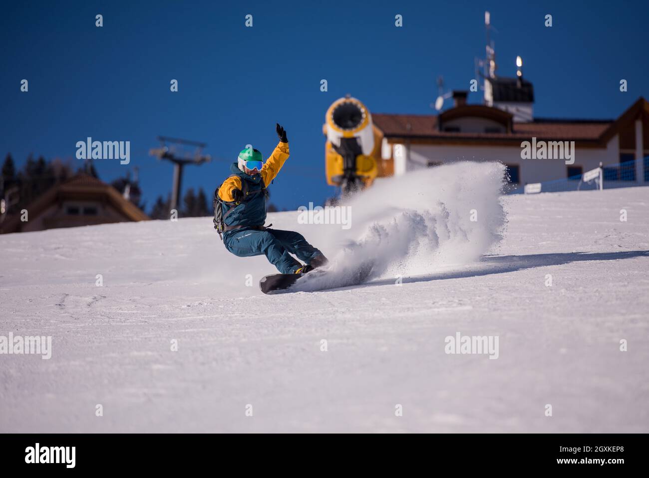Young freestyle snowboarder running down the slope and ride free style ...