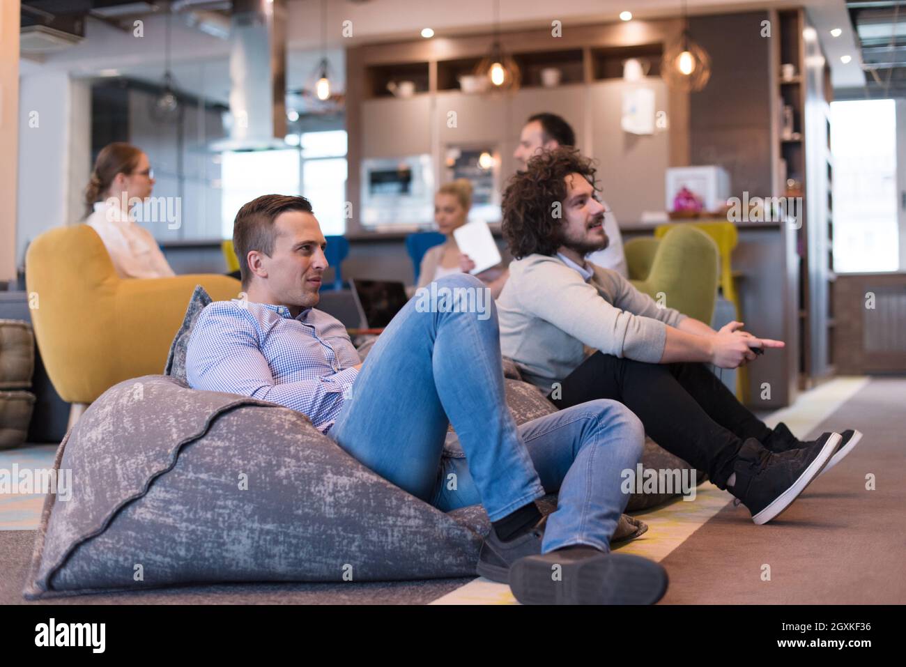 Work hard play hard. Workers Playing computer games in creative startup ...