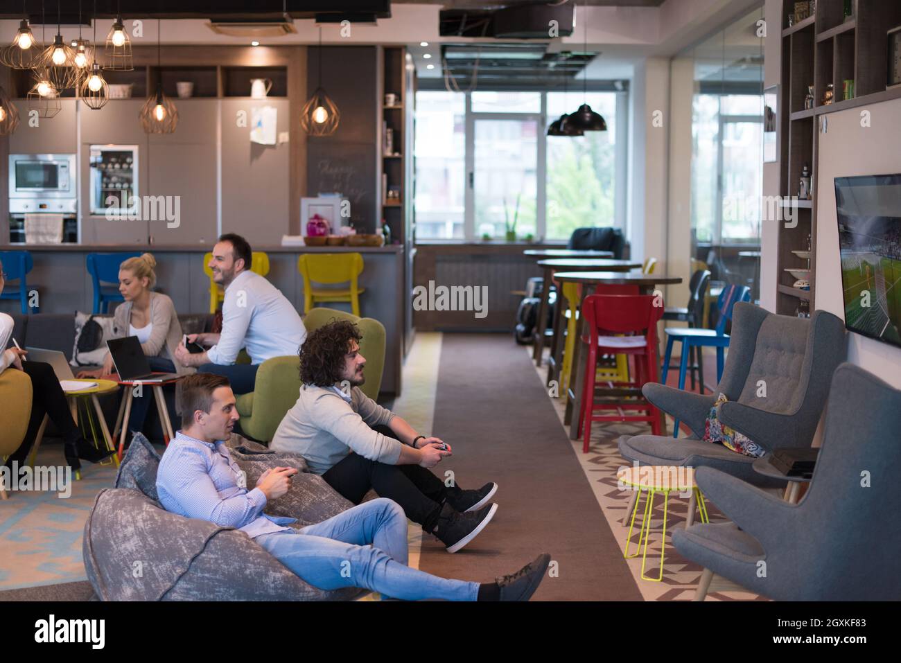 Work hard play hard. Workers Playing computer games in creative startup ...
