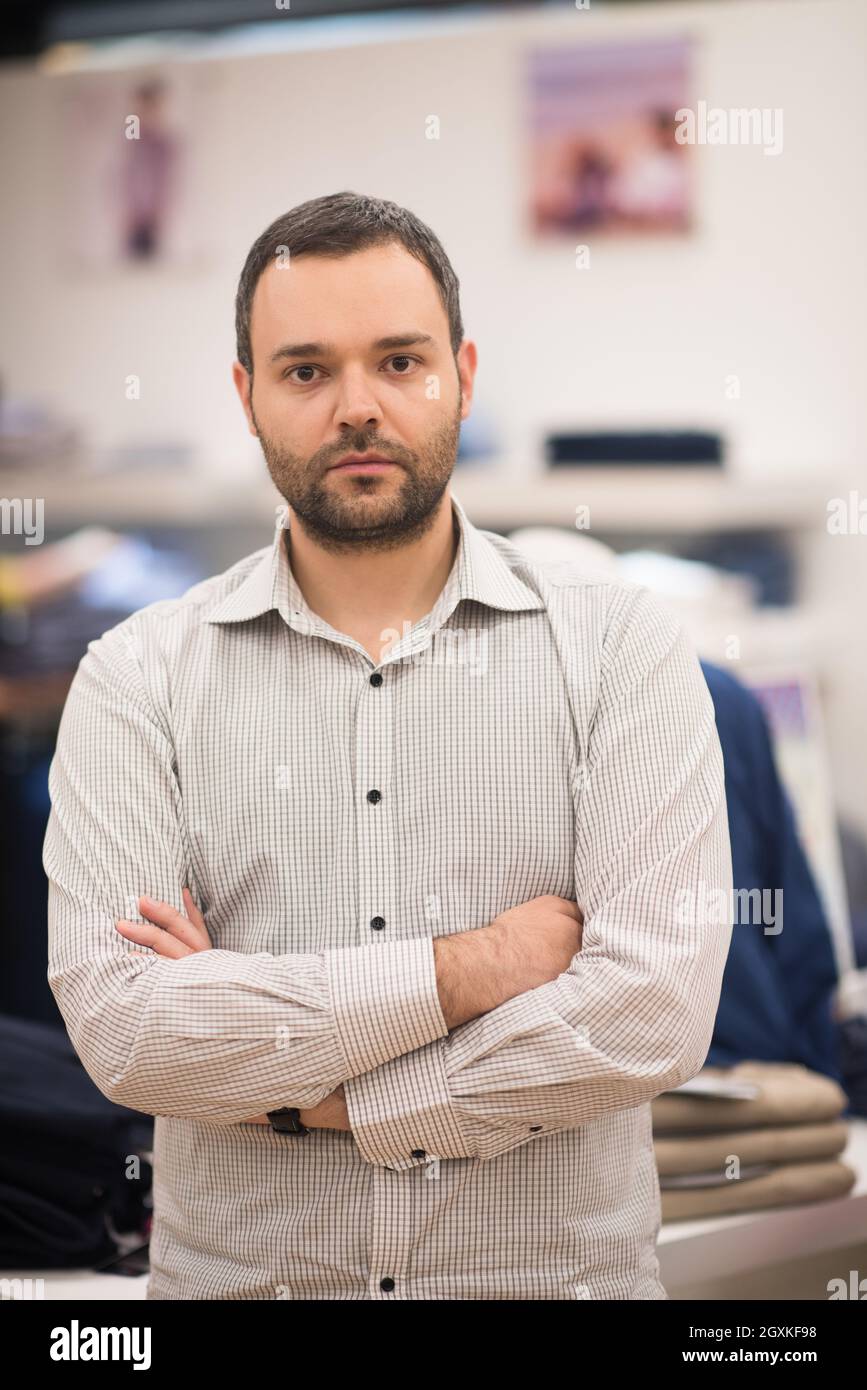 Portrait of an attractive man Shopping In A Man's Clothing Store Stock ...