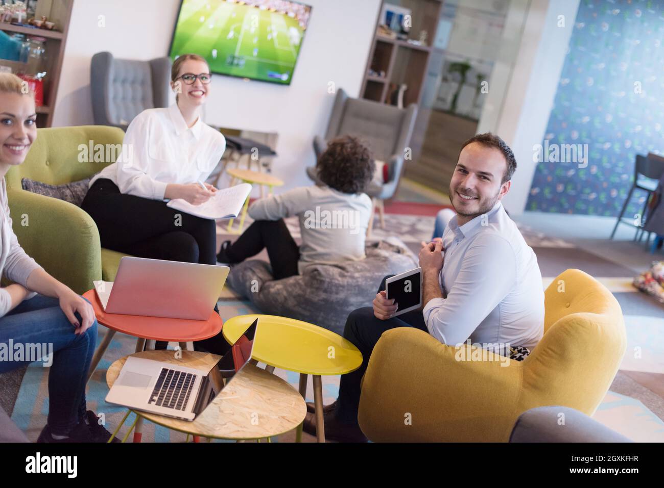 Group of a young business people discussing business plan at modern ...