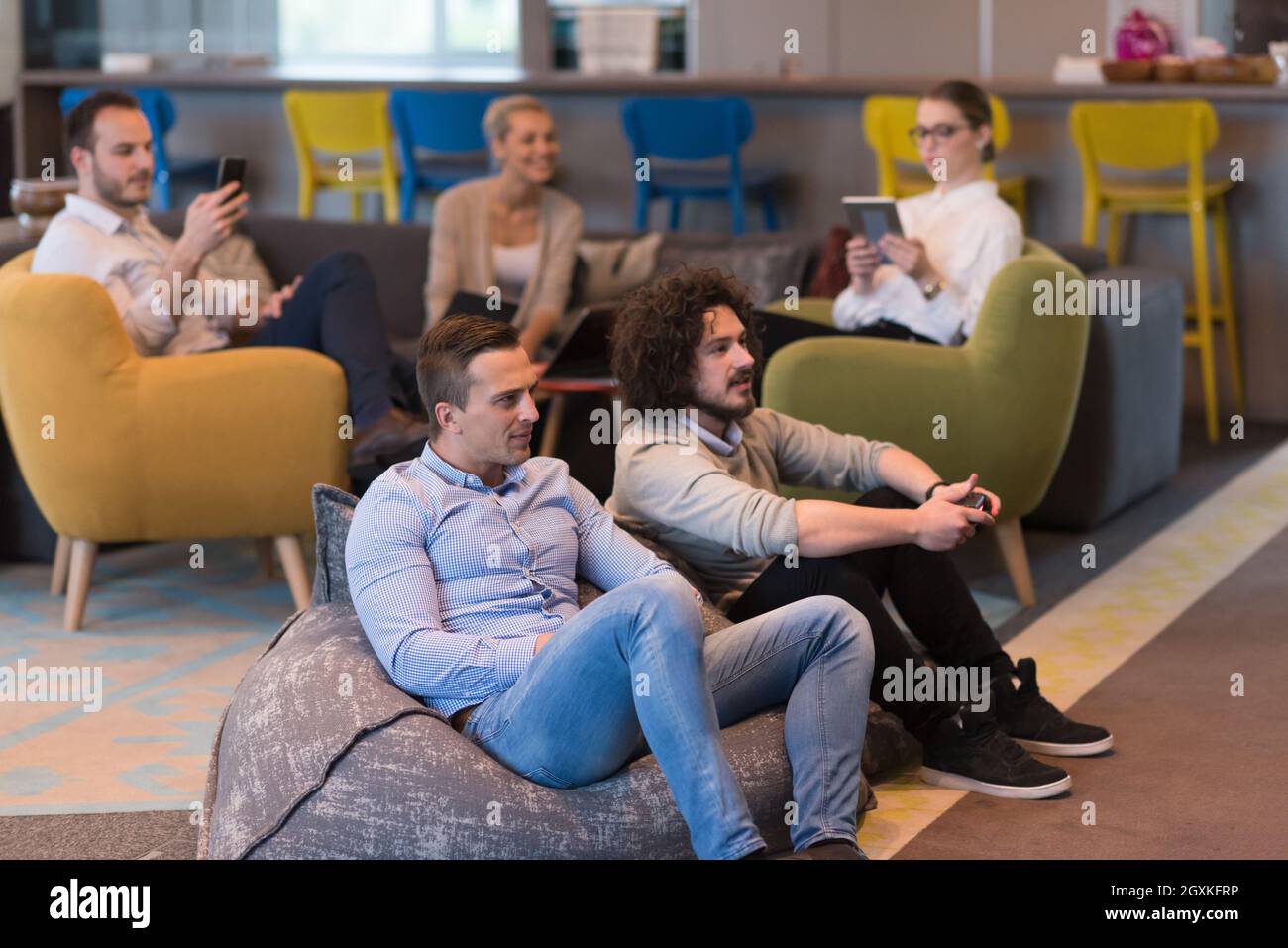 Work hard play hard. Workers Playing computer games in creative startup ...