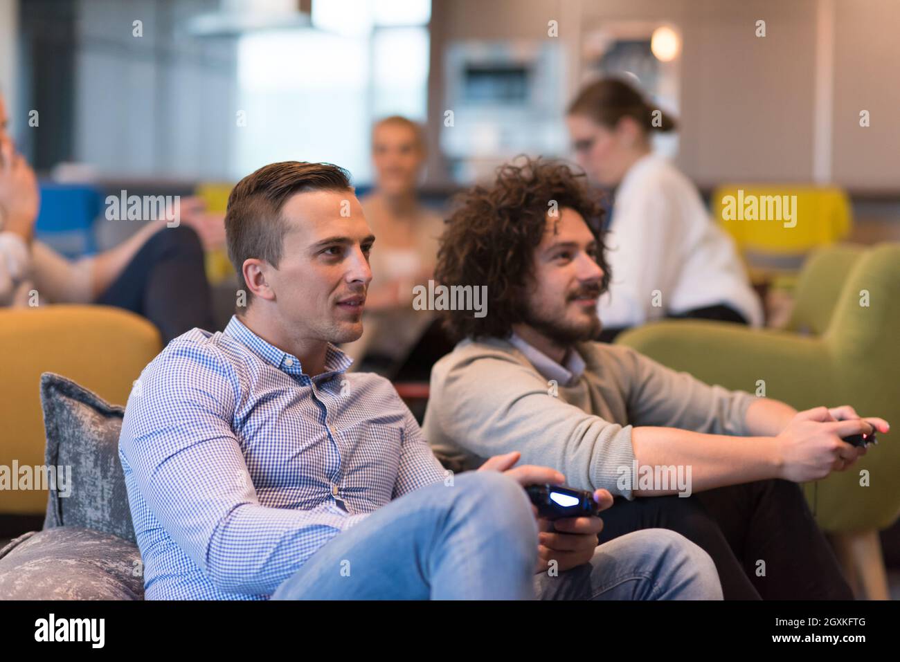 Work hard play hard. Workers Playing computer games in creative startup ...